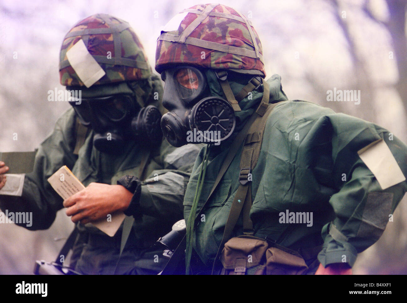 Soldiers from the T A wearing nuclear and biological suits and masks ...