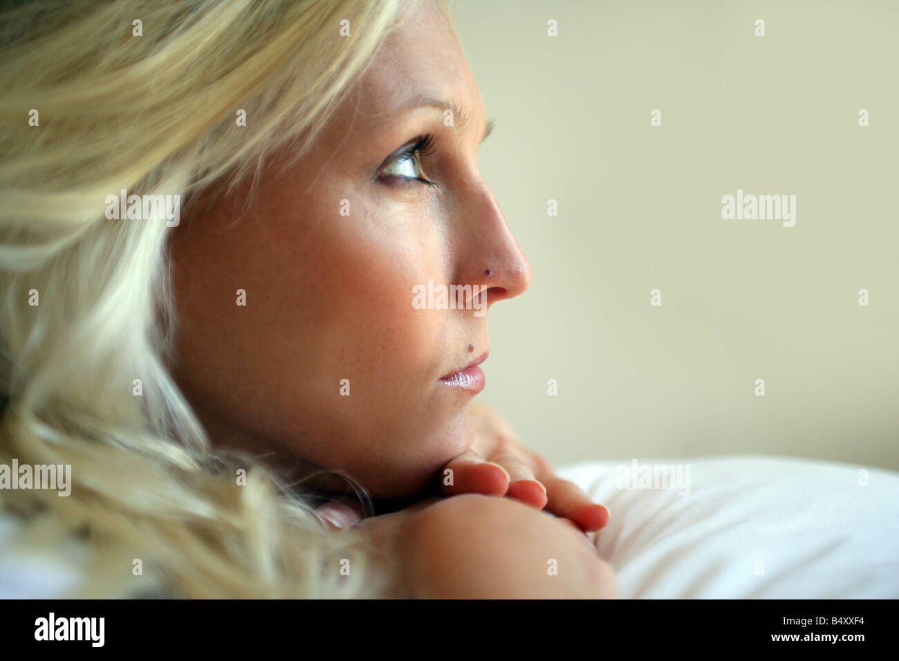 Young woman thinking, side view Stock Photo - Alamy
