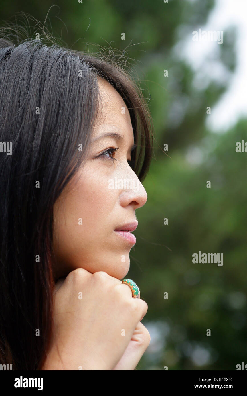 Young woman thinking, side view Stock Photo - Alamy