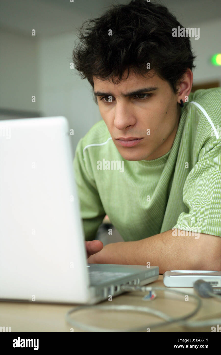 Young man using laptop Stock Photo - Alamy