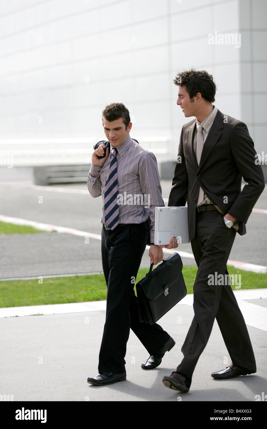 Two businessmen walk talk together hi-res stock photography and images ...