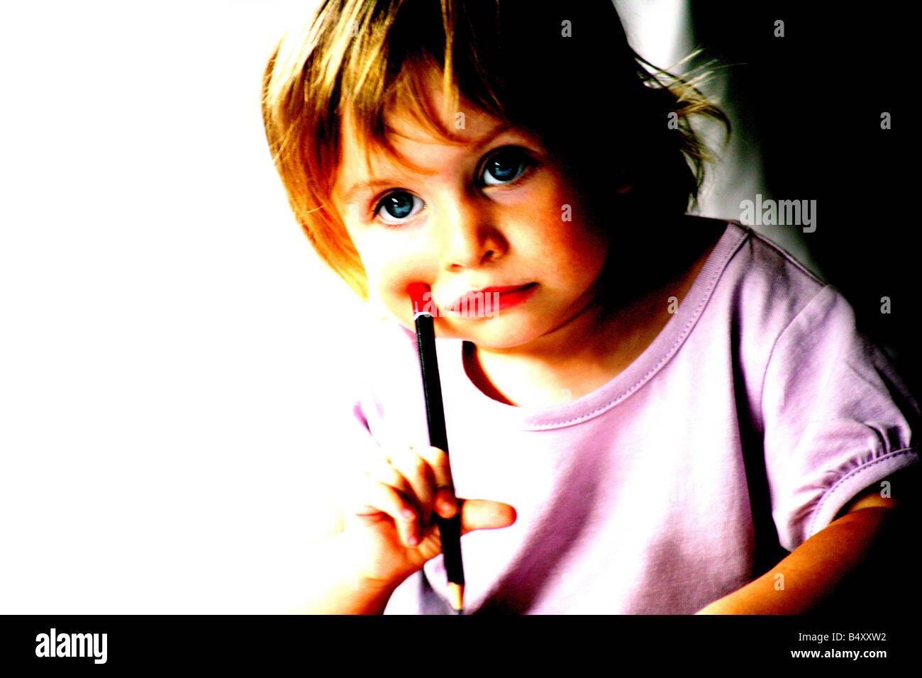 Girl holding pencil Stock Photo - Alamy
