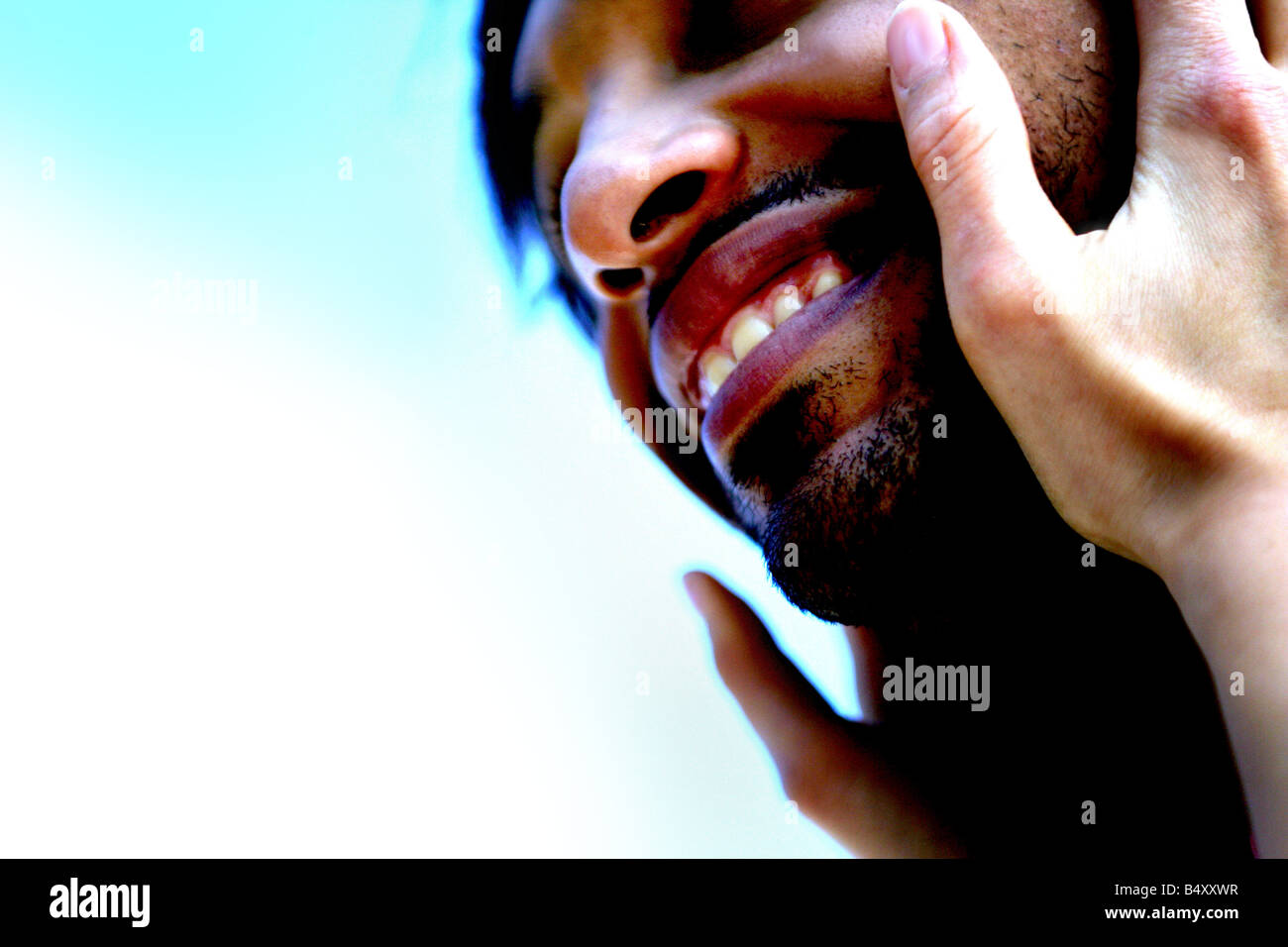 Woman's hands on man's face Stock Photo - Alamy