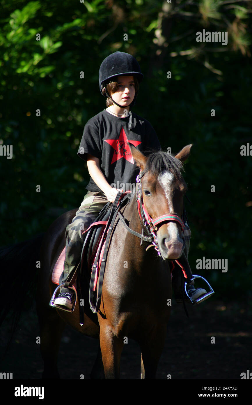 Boy riding horse Stock Photo - Alamy