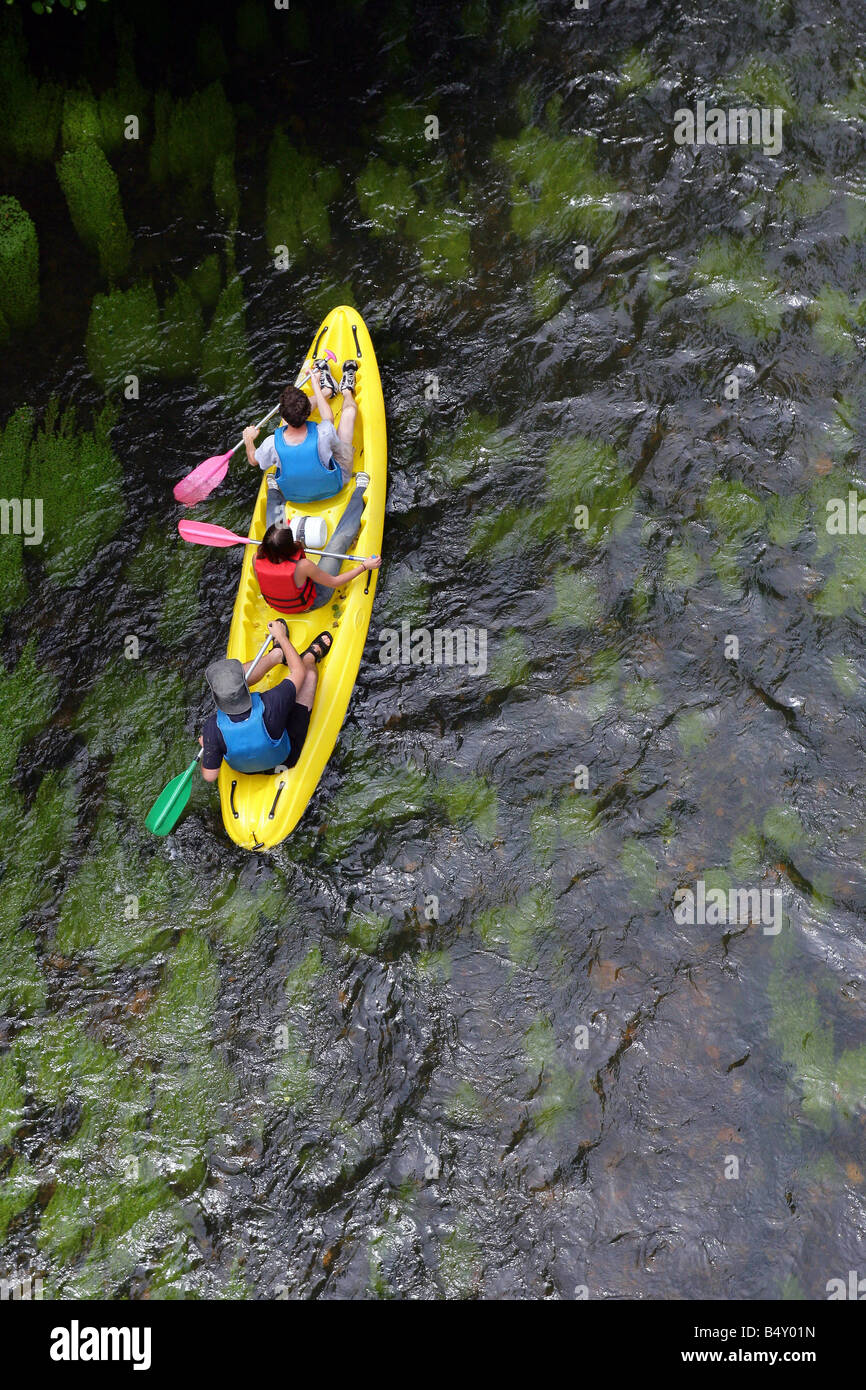 Three people paddling an inflatable raft in river, overhead view Stock ...