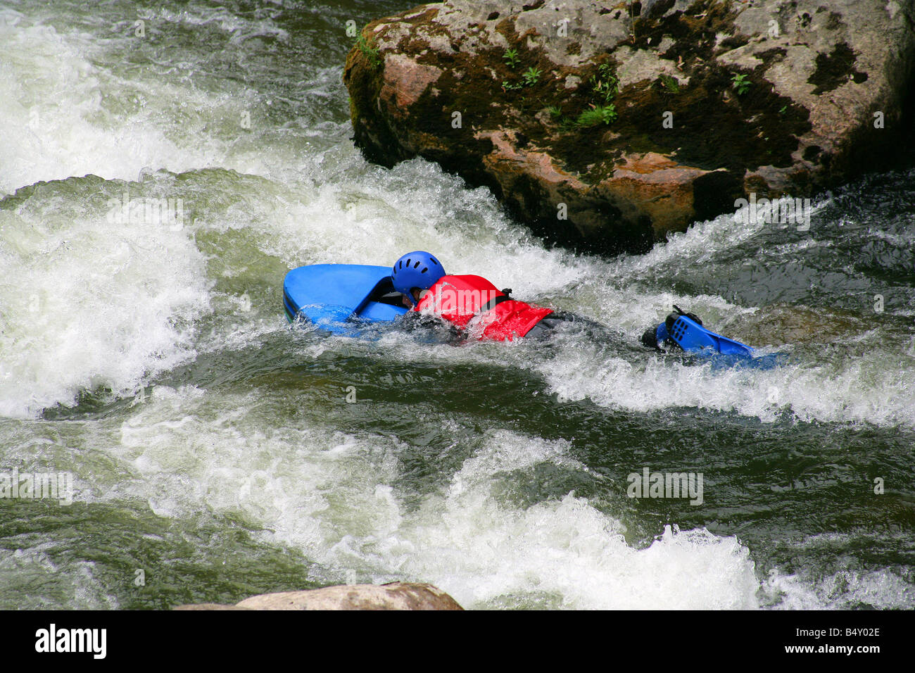 Person on inflatable raft in stream Stock Photo - Alamy