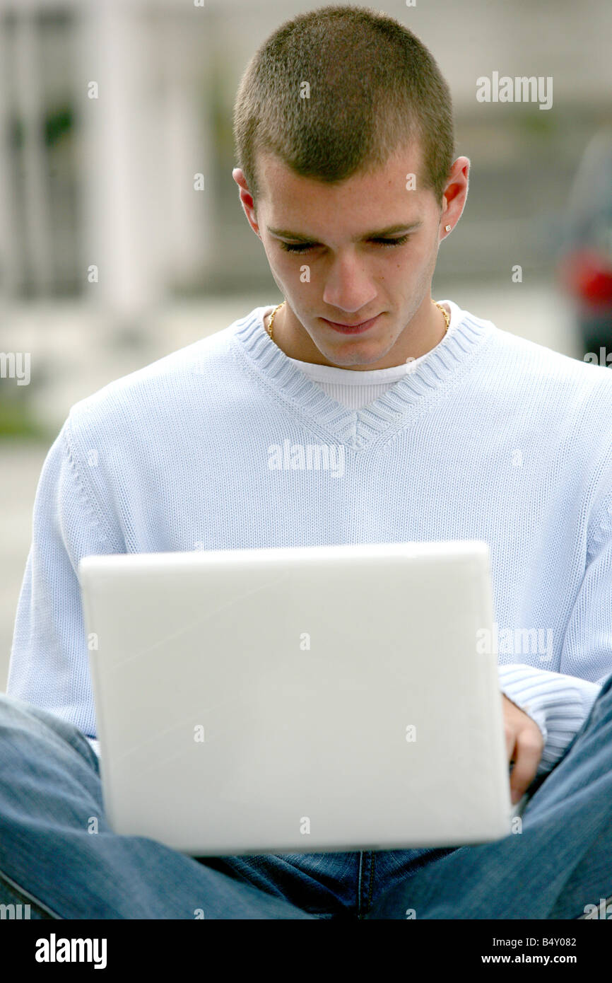 Young man using laptop Stock Photo - Alamy