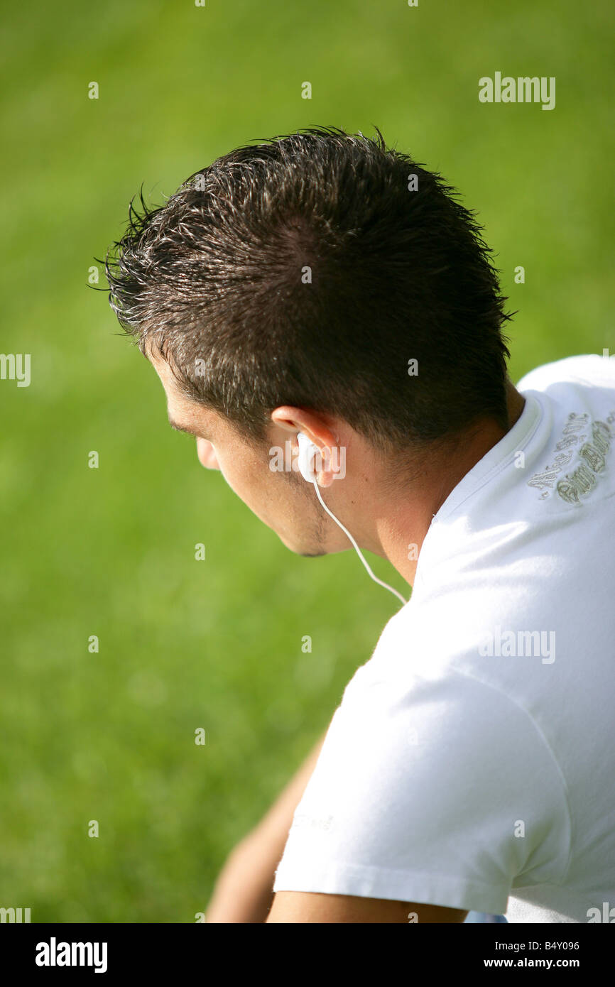 Young man listening music, side view Stock Photo - Alamy