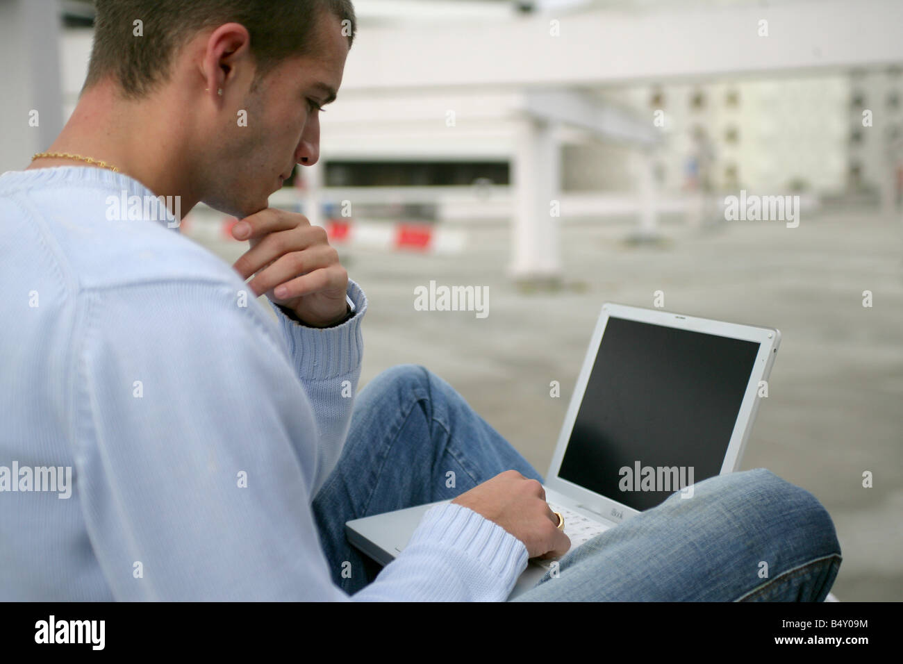 Young man using laptop Stock Photo - Alamy