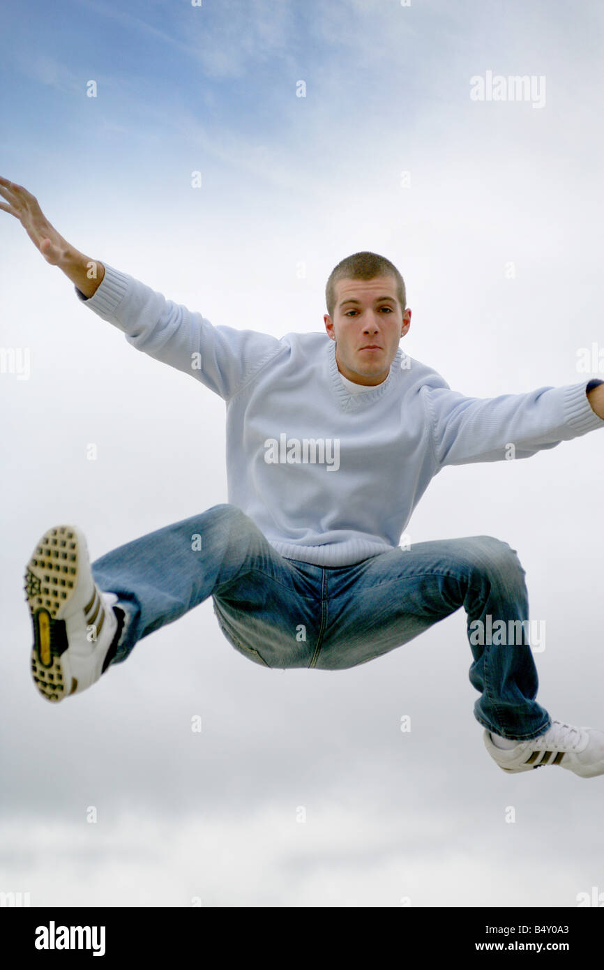 Young man jumping in the air Stock Photo - Alamy