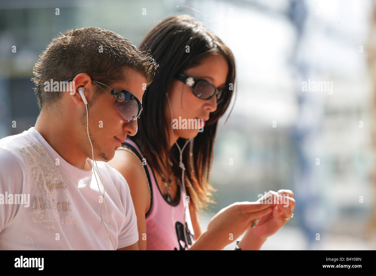 Young couple listening to music, side view Stock Photo - Alamy