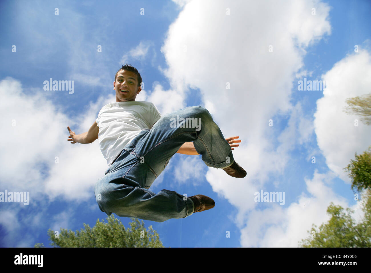 Young man jumping, mid-air Stock Photo - Alamy