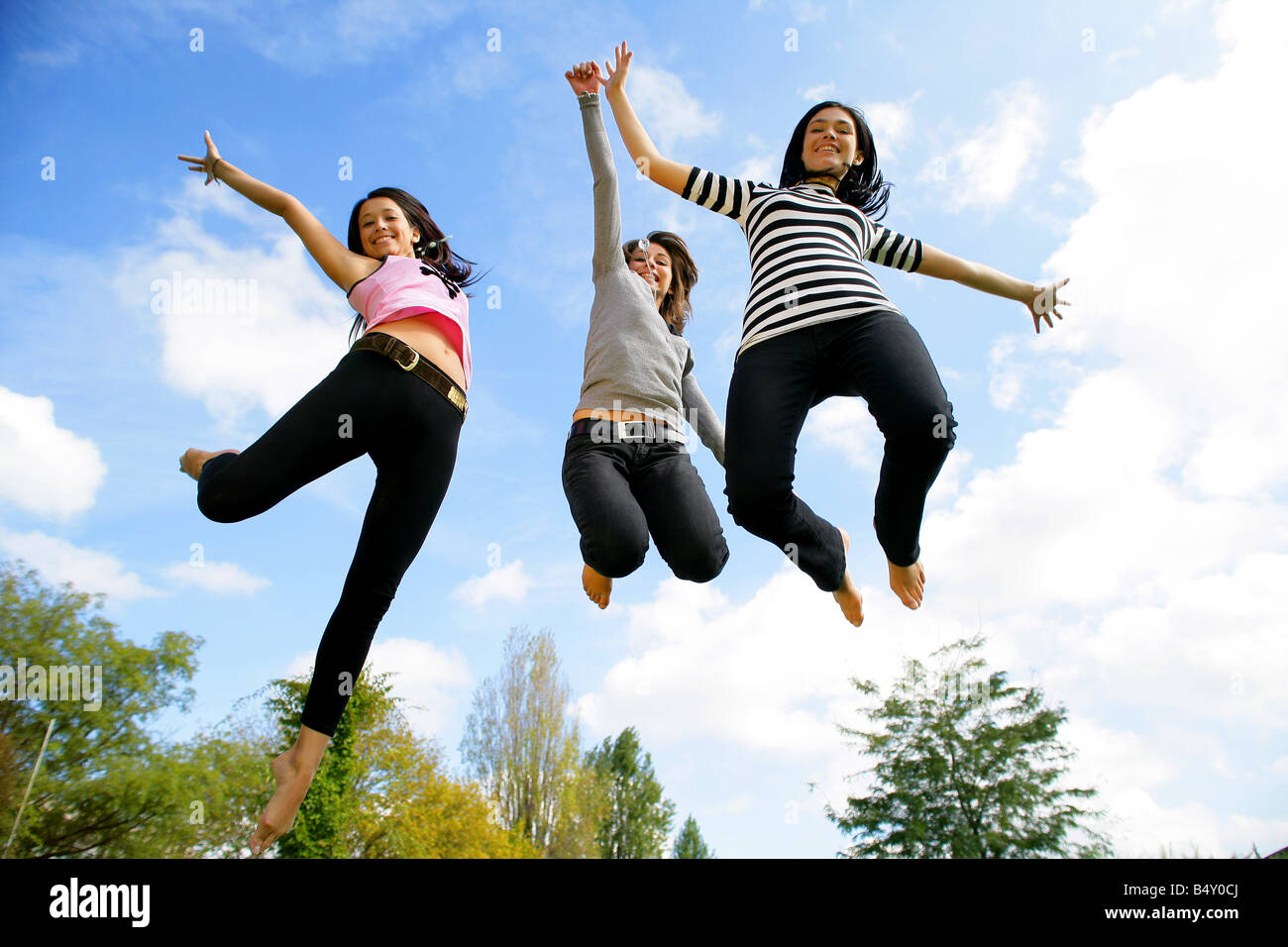 Young women jumping Stock Photo - Alamy