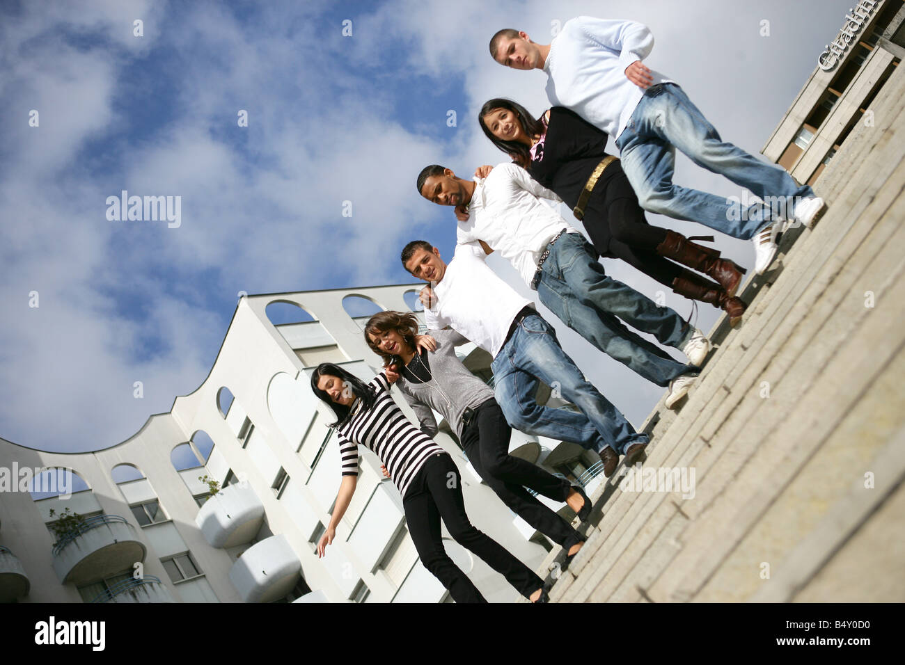 Group of friends walking down steps, low angle view Stock Photo - Alamy