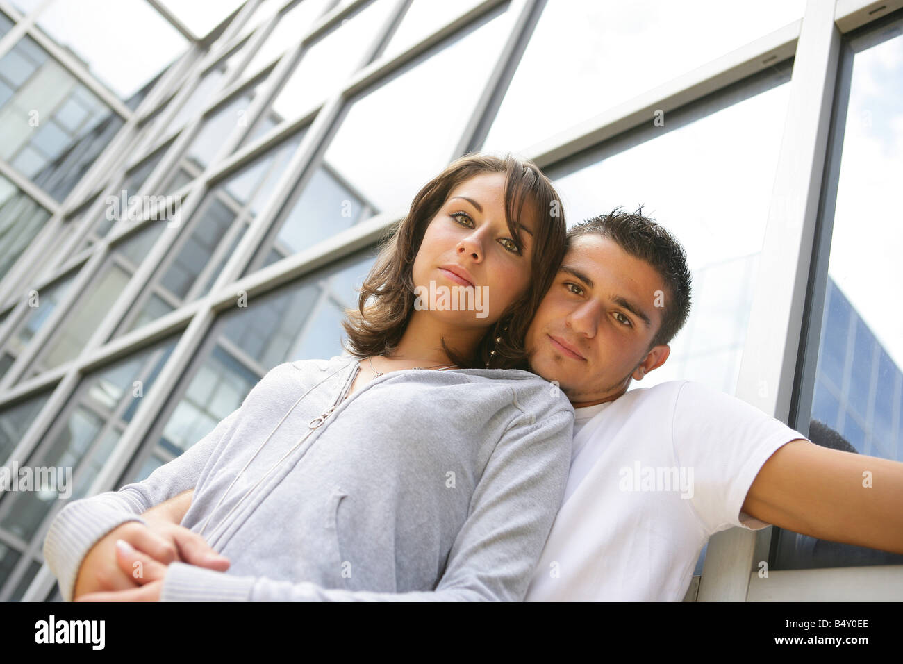 Couple standing outside building Stock Photo - Alamy