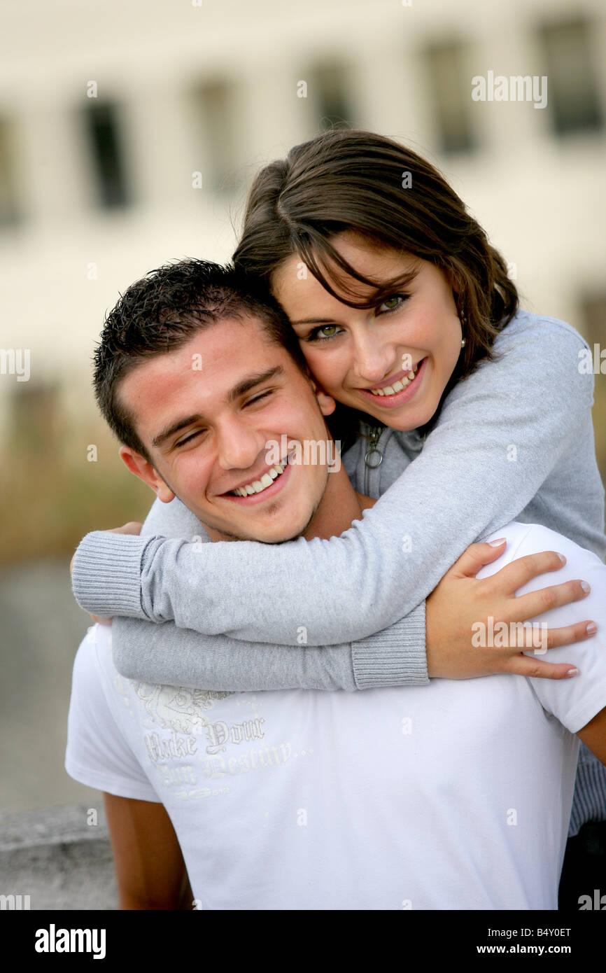 Couple hugging outside building Stock Photo - Alamy
