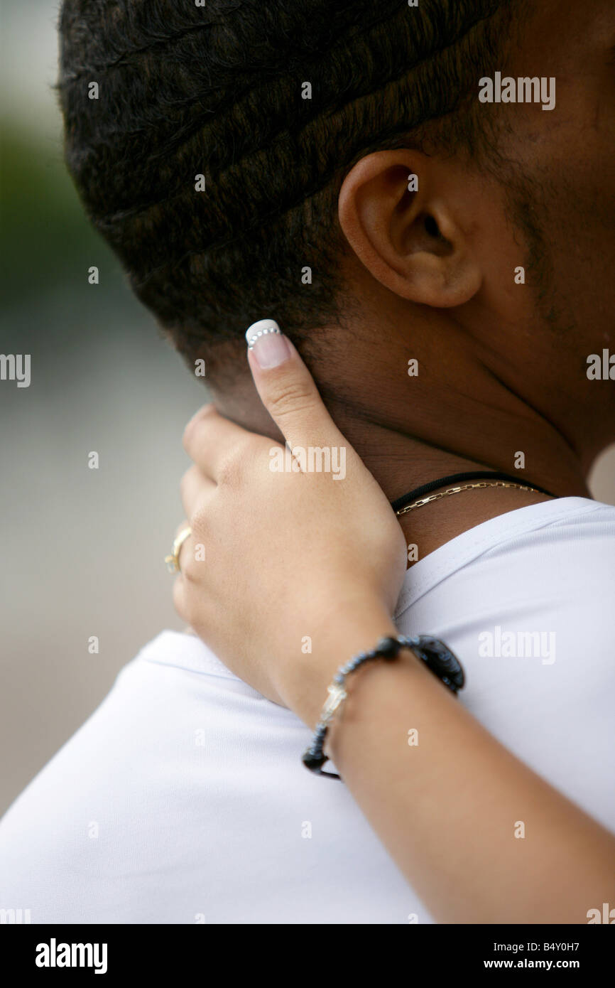 Young man with hand on neck, rear view Stock Photo - Alamy