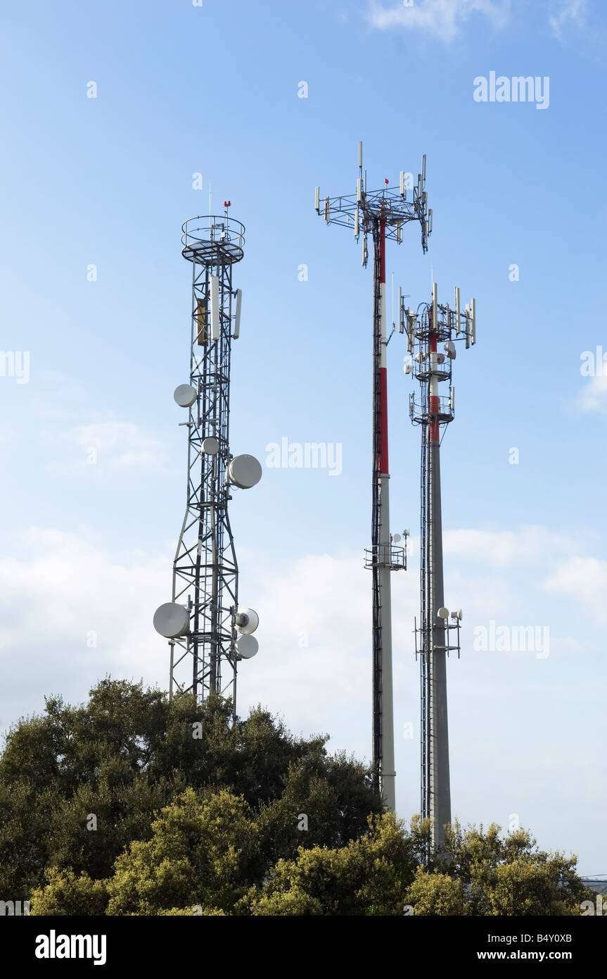 Three telecommunication antennas against a clear blue sky Stock Photo ...