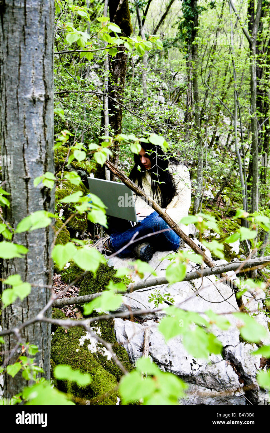 young woman with laptop in the wood Stock Photo - Alamy