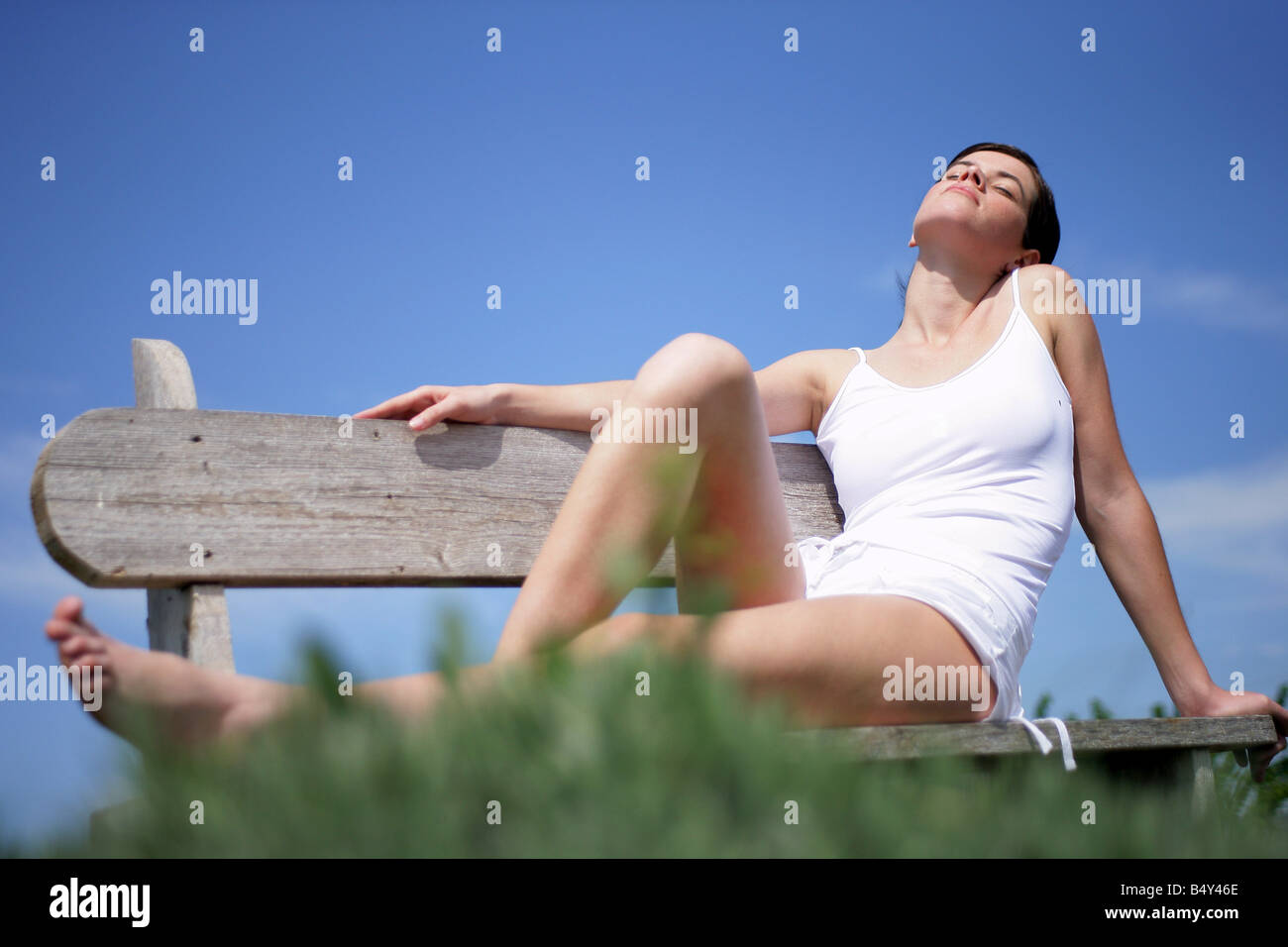 young woman relaxing on a bench Stock Photo - Alamy