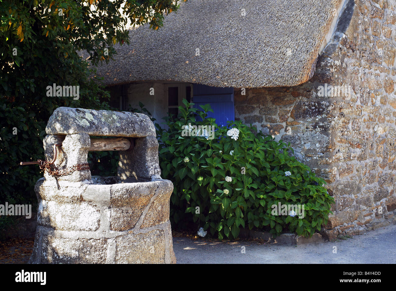 stone house facade and well Stock Photo - Alamy