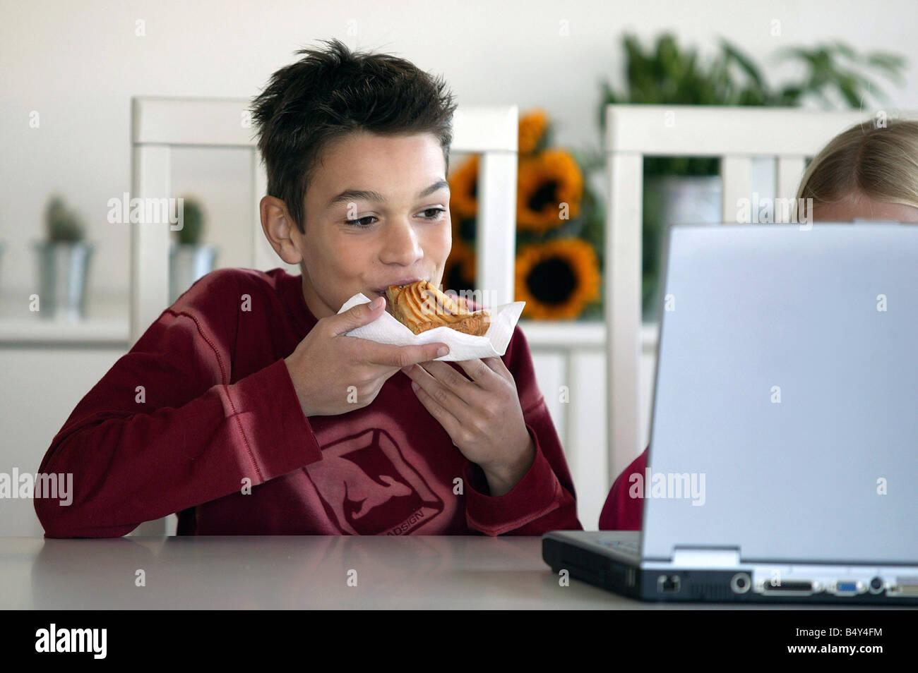 young boy in front of a laptop with apple tart Stock Photo - Alamy