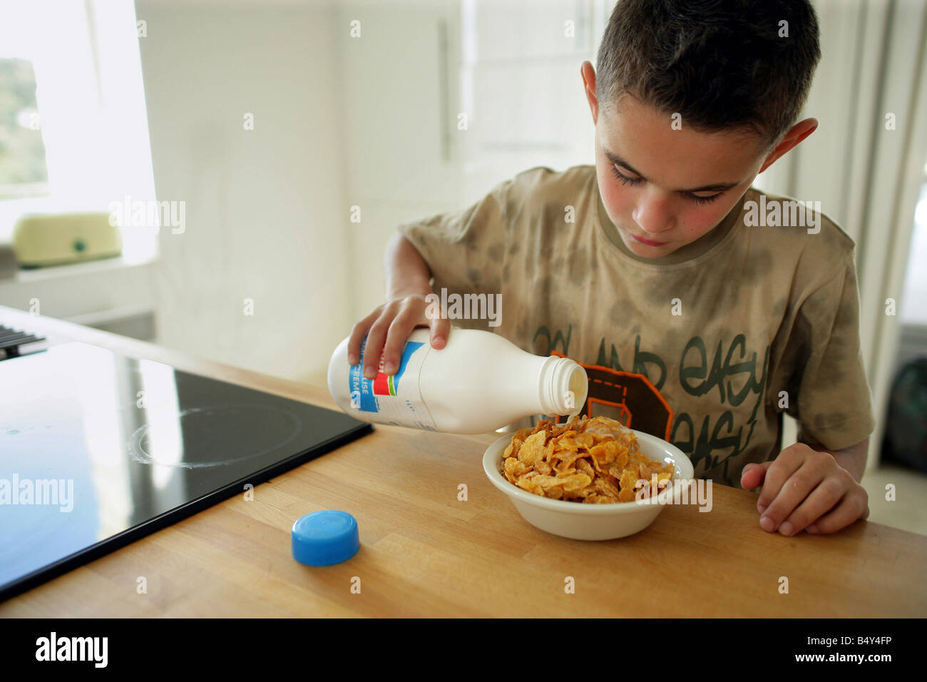 young boy preparing a cereal bowl Stock Photo - Alamy