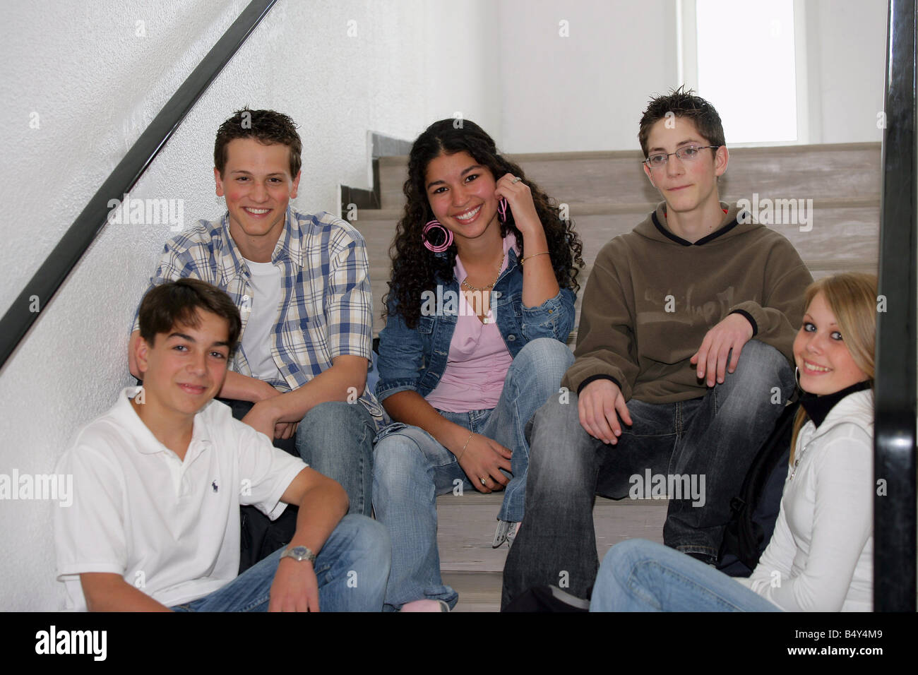 friends team sitting in the corridor Stock Photo - Alamy