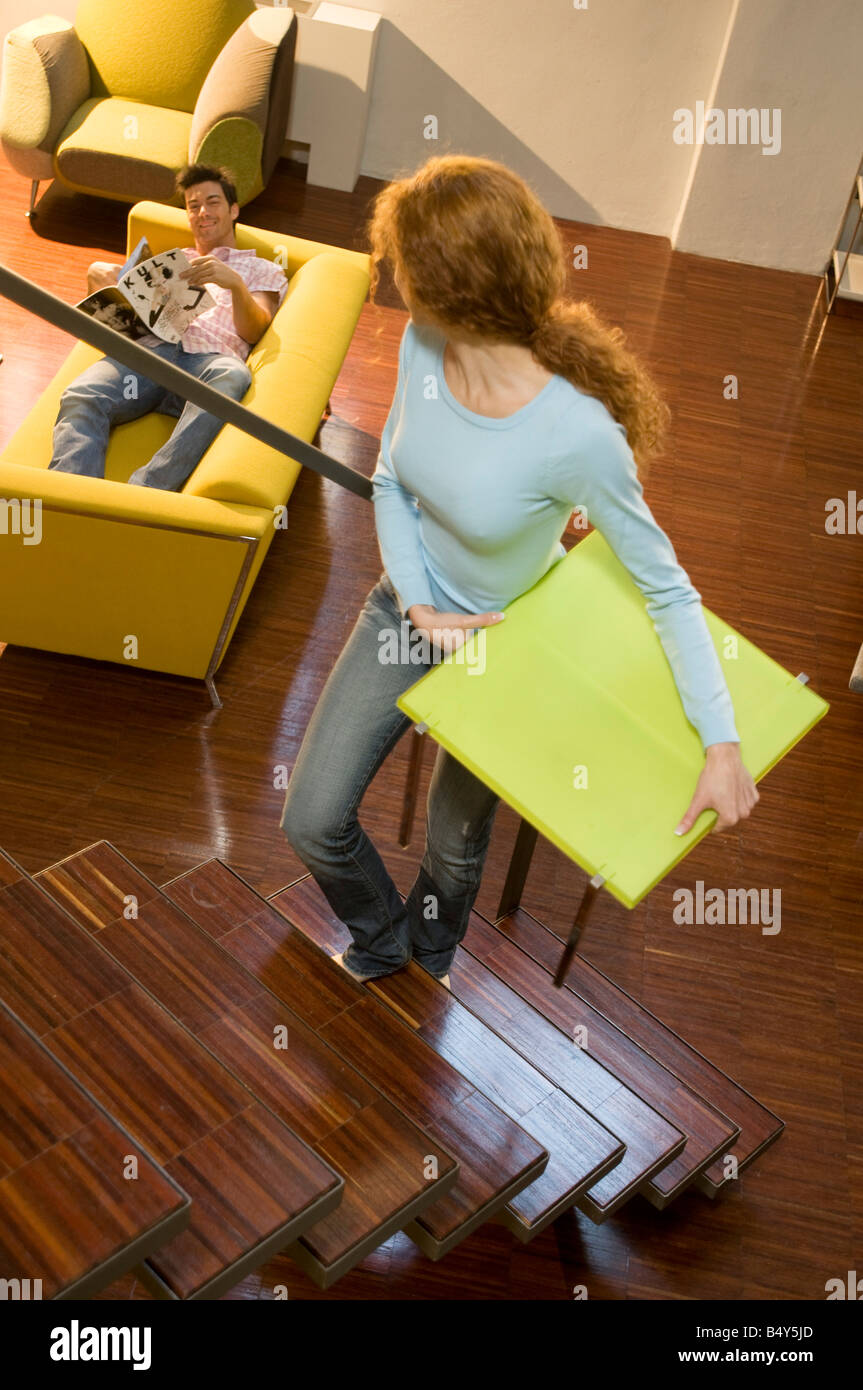 woman carrying a small table Stock Photo - Alamy
