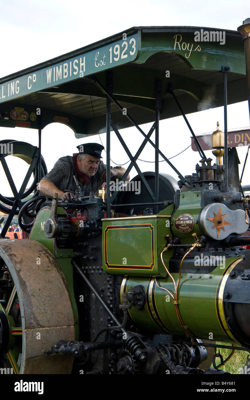 Traction engine driver concentrating on the operation of his machine ...