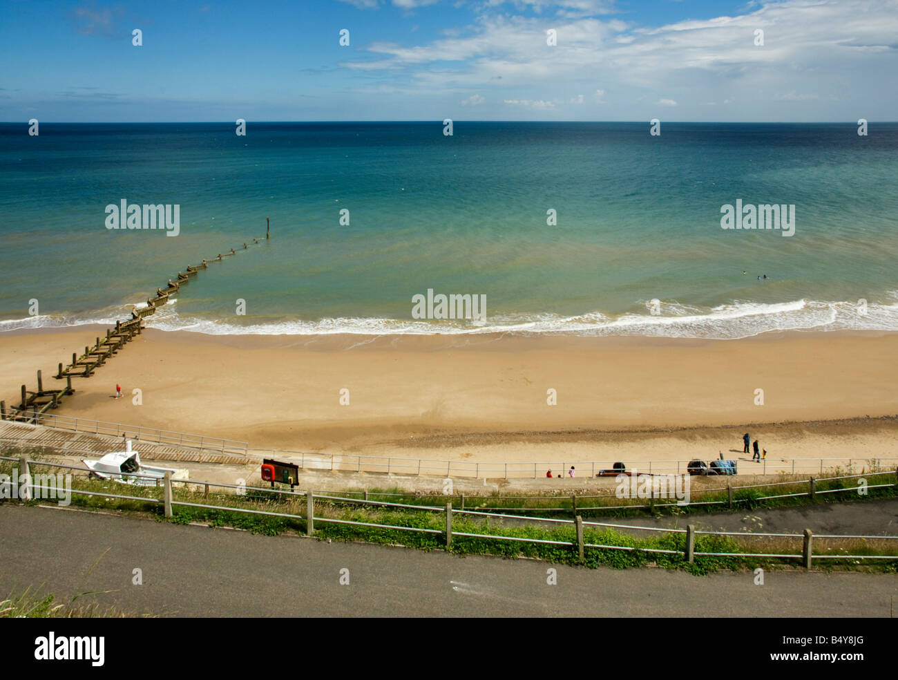 Overstrand beach with people swimming Stock Photo - Alamy