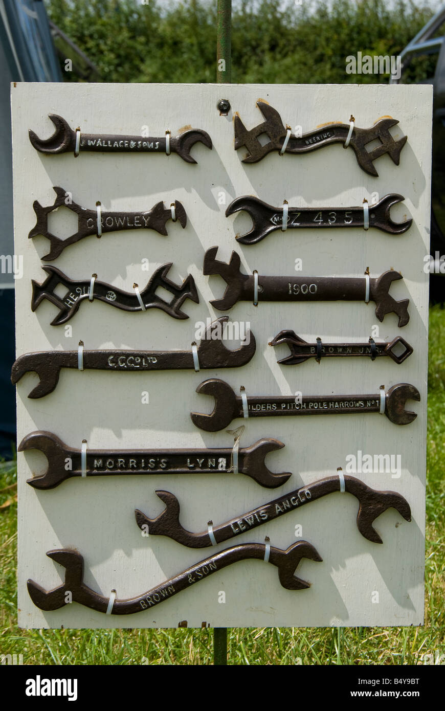 A collection of old vintage, spanners mounted on a board and displayed ...