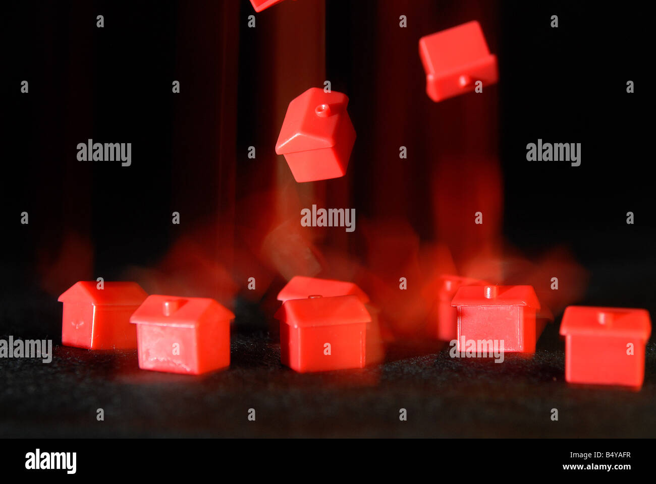 Monopoly houses falling Stock Photo - Alamy