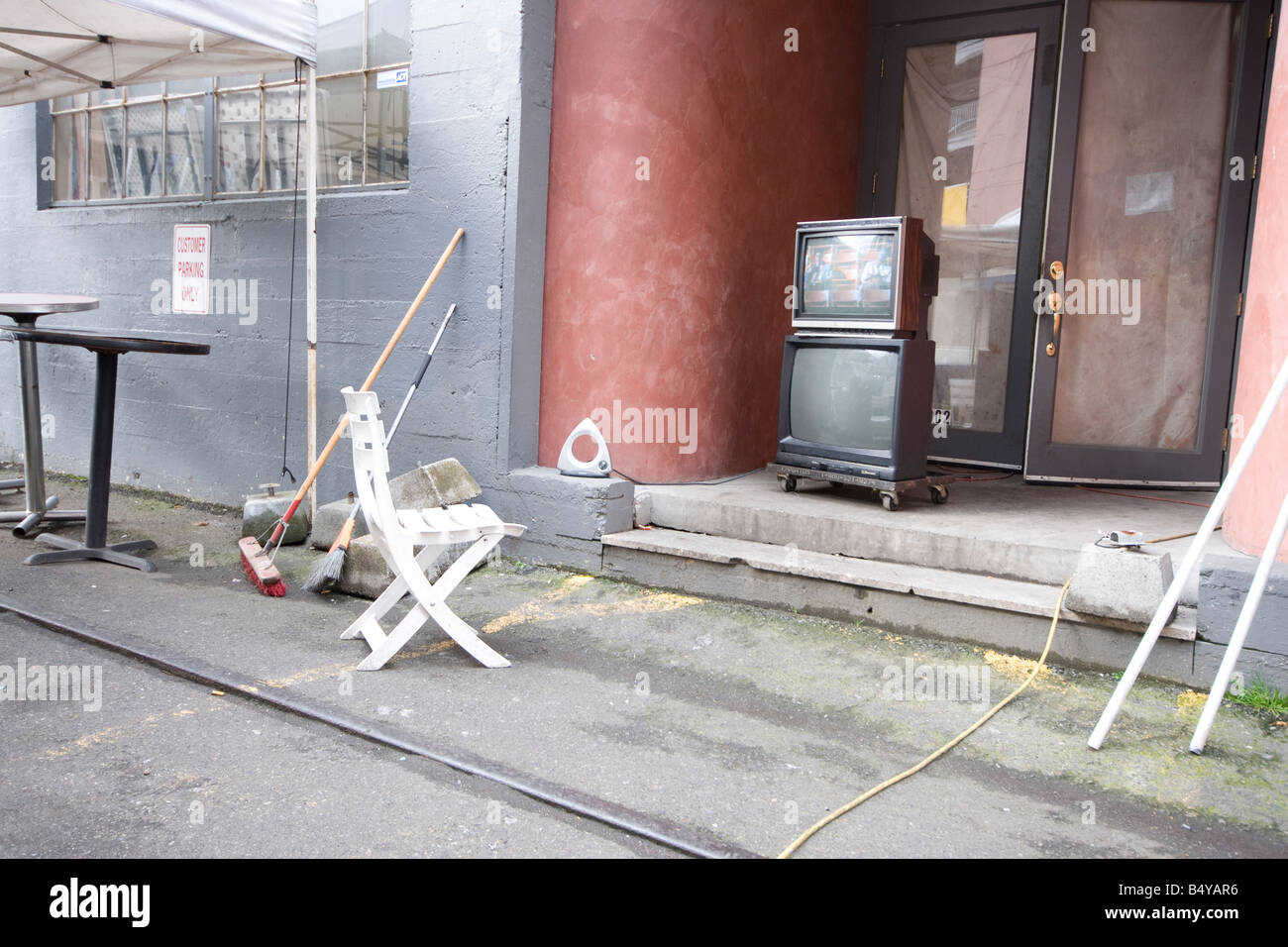 A TV and chair set up on the street Stock Photo - Alamy