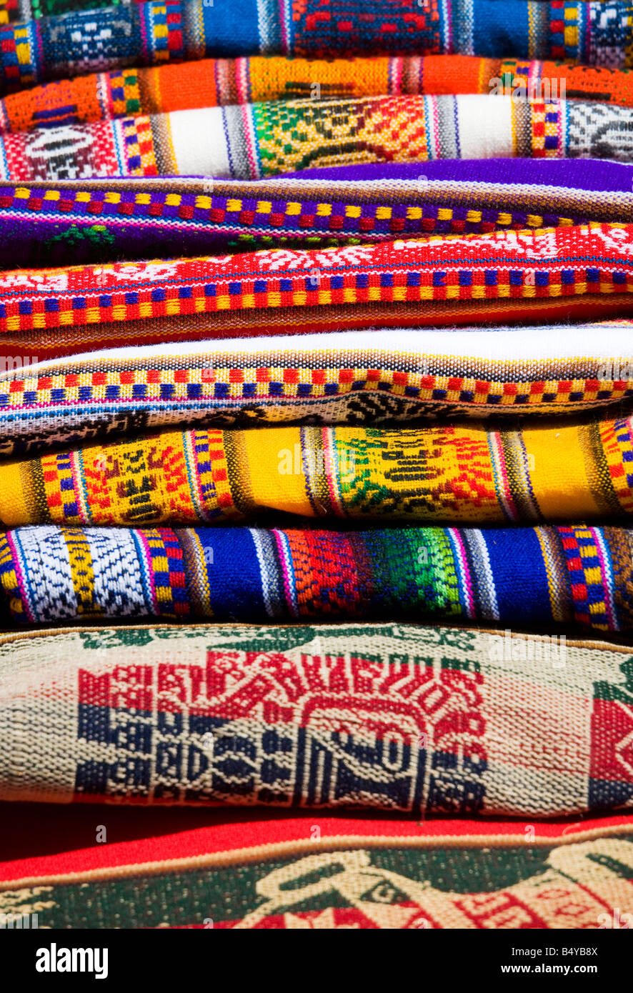 Piles of Peruvian Andean blankets folded neatly to give a colourful ...