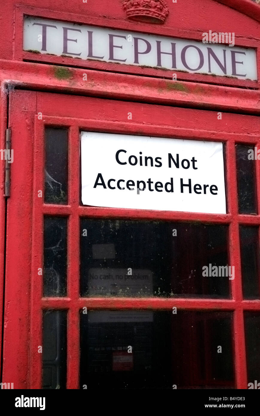 red telephone box with sign reading no coins accepted Stock Photo - Alamy