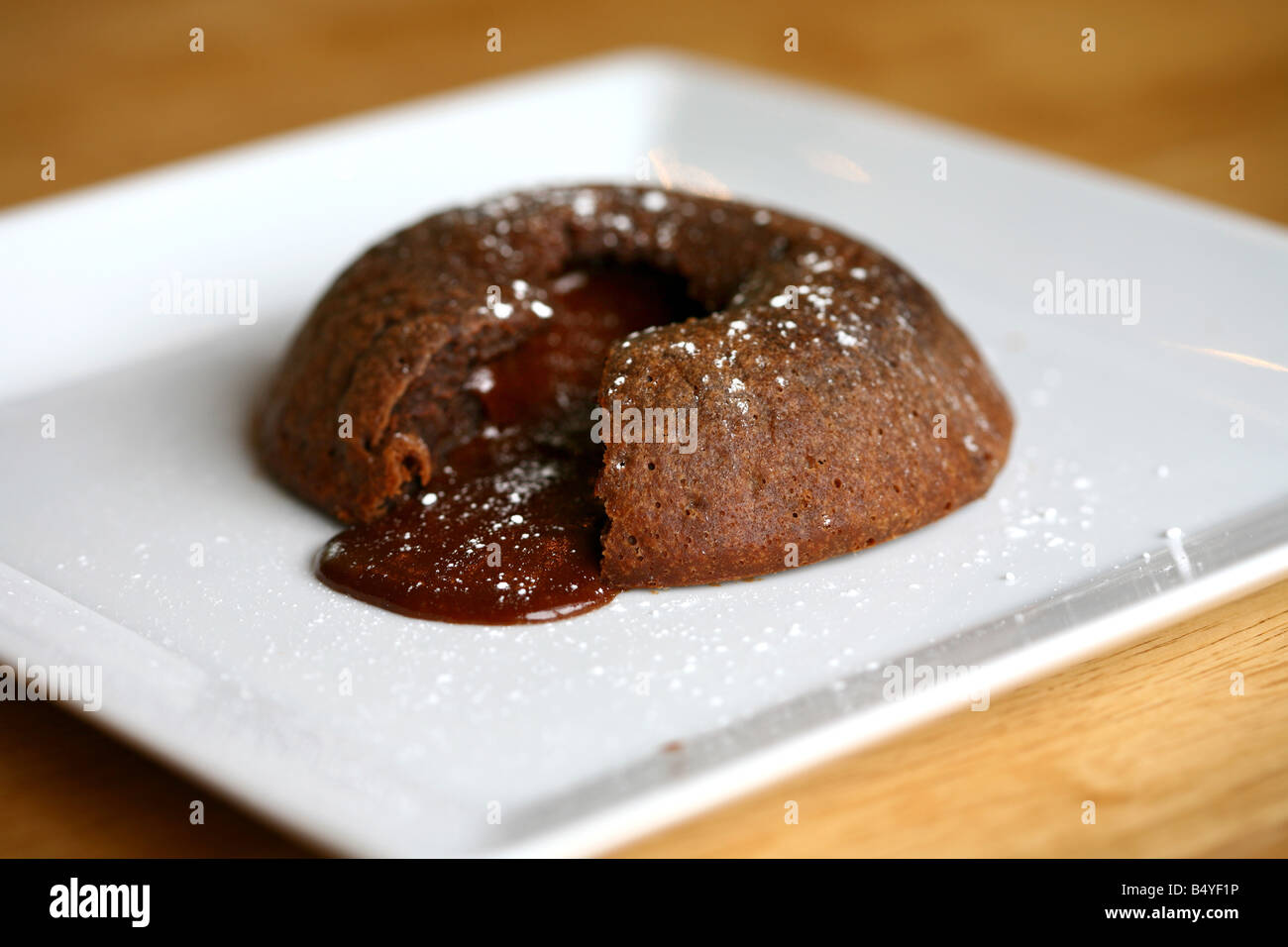 Chocolate pudding with a warm soft centre on a square plate Stock Photo ...