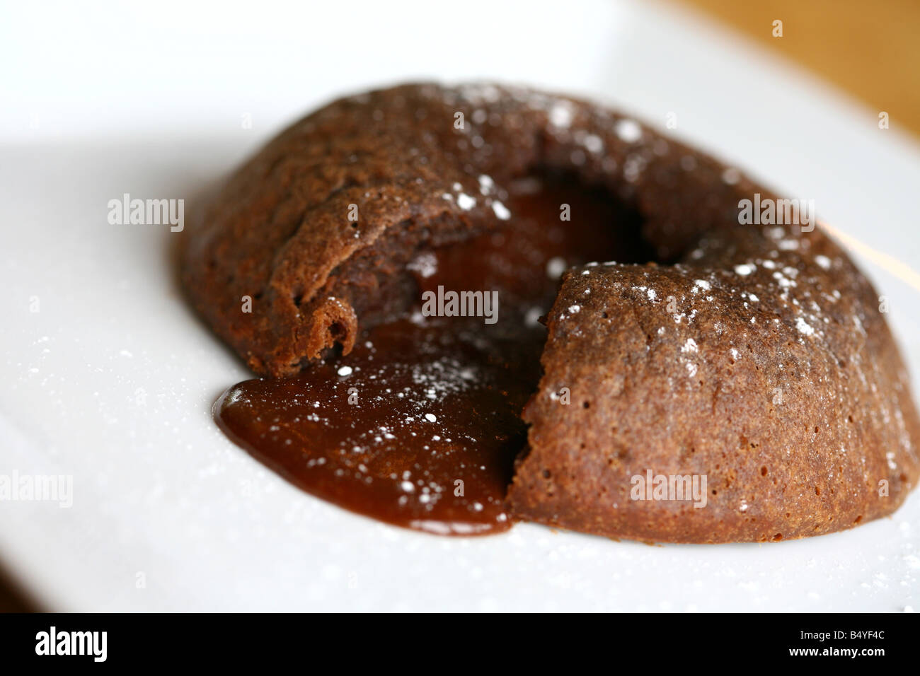 Chocolate pudding with a warm soft centre on a square plate Stock Photo ...