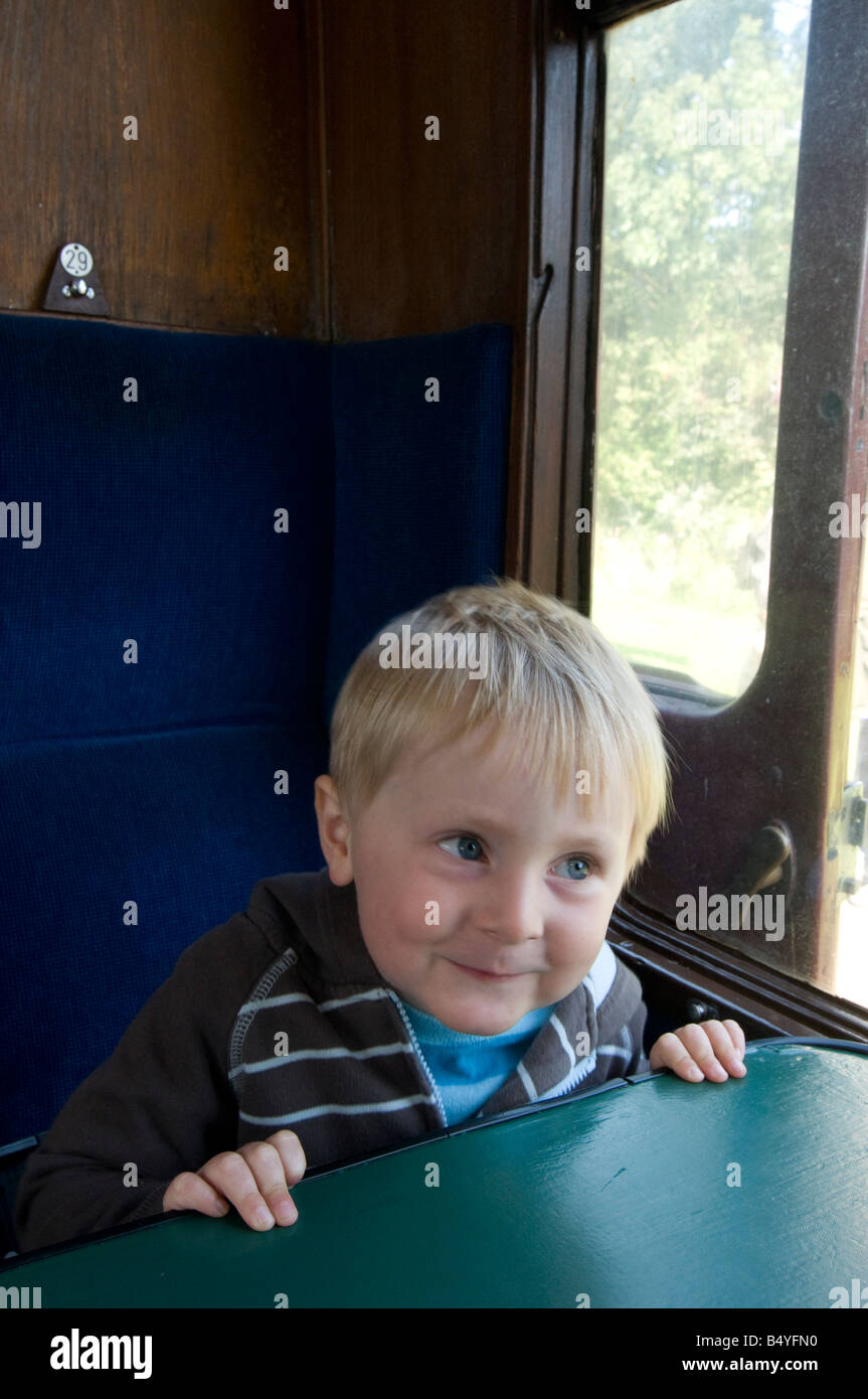 Excited boy in steam train railway carriage Stock Photo - Alamy