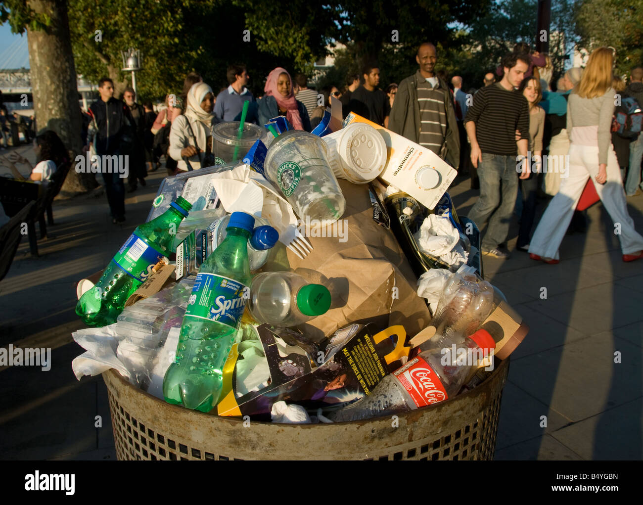 Rubbish bin over flowing Stock Photo - Alamy