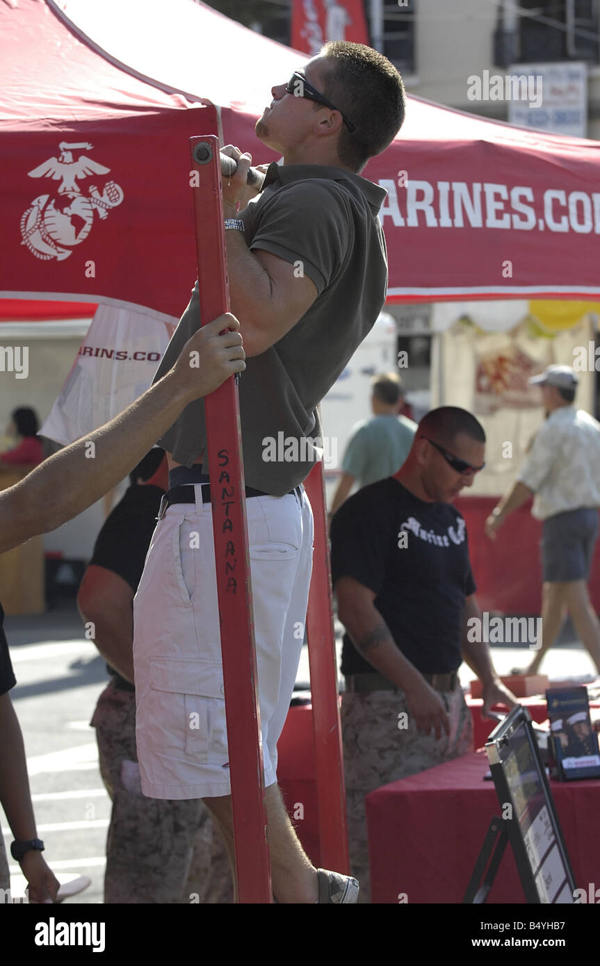 Visitors to a US Marine Corps recruiting booth at a street fair ...
