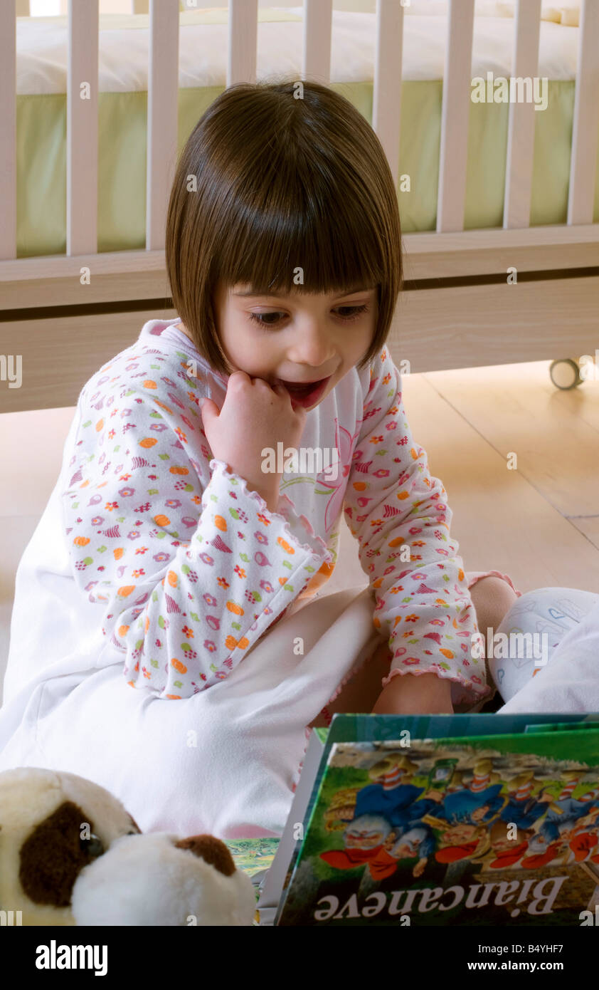 little girl reading a book, pyjama Stock Photo - Alamy