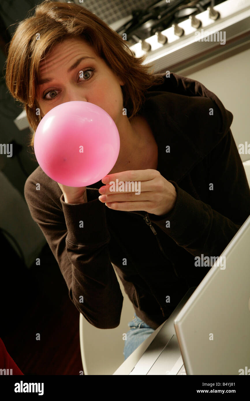 woman inflating a balloon Stock Photo - Alamy