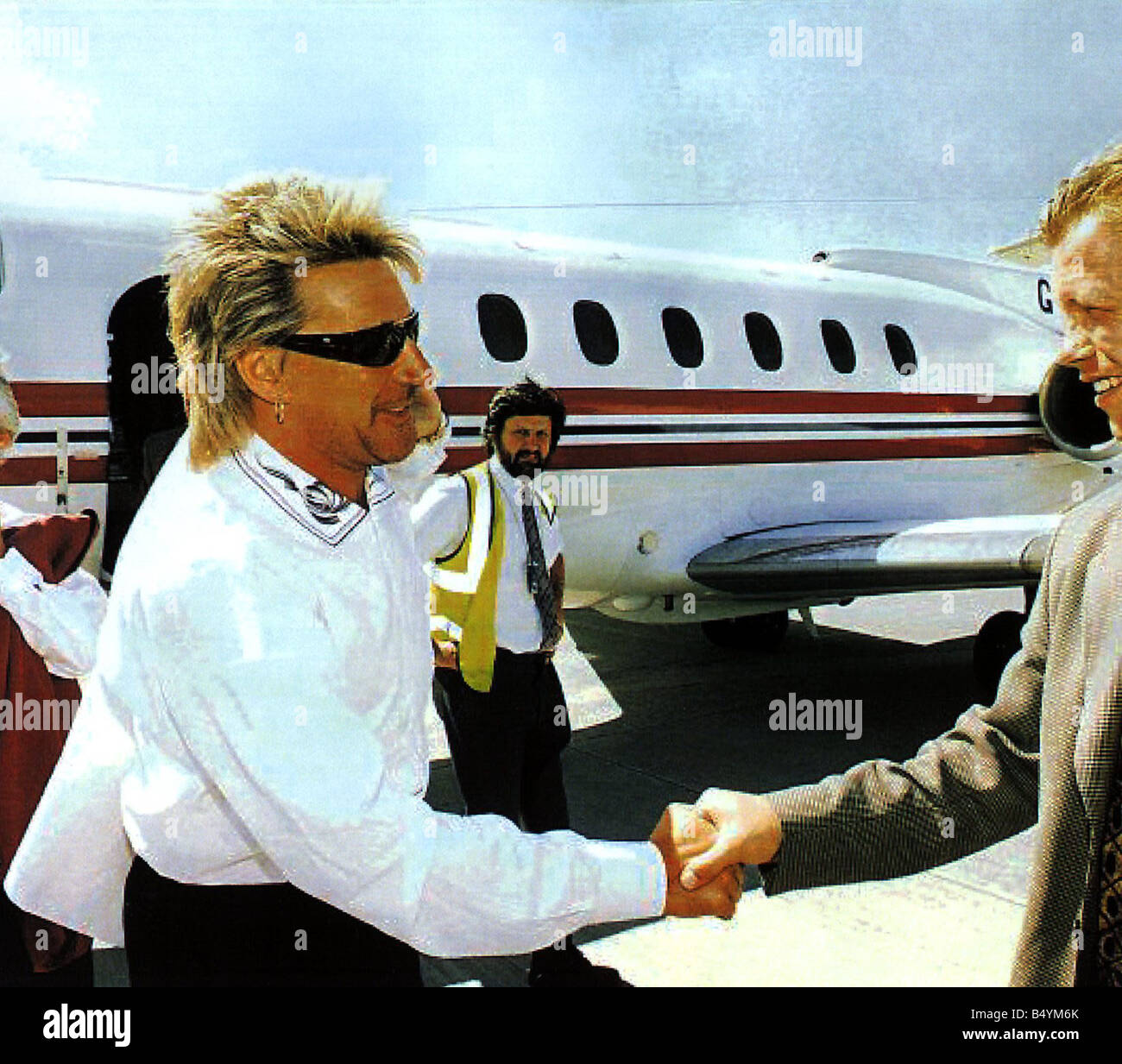 Singer Rod Stewart showing his Learjet in background Stock Photo - Alamy