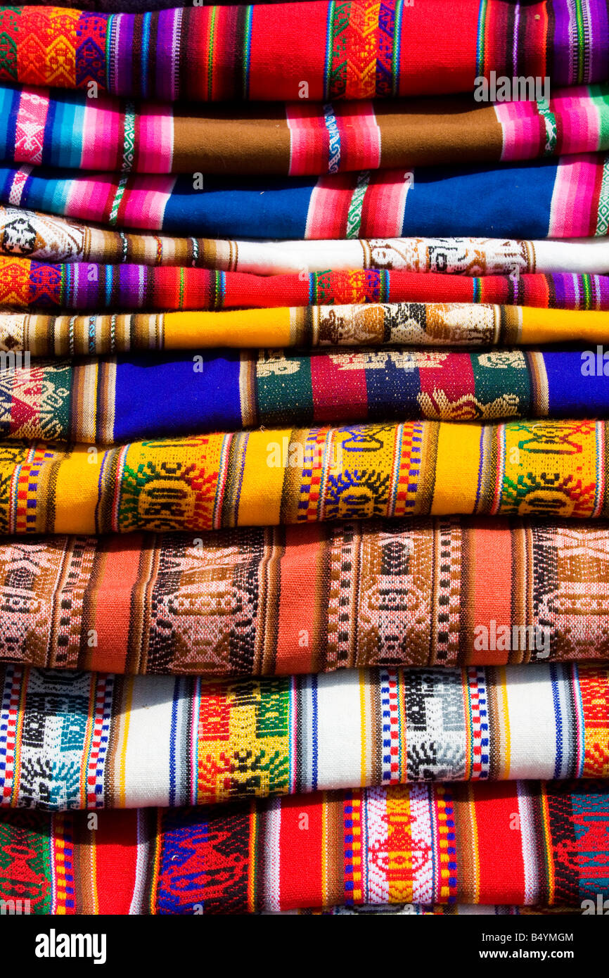 Piles of Peruvian Andean blankets folded neatly to give a colourful ...