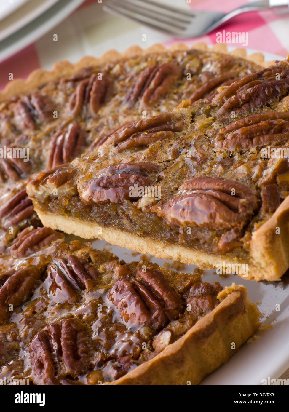 Pecan Pie With A Slice Being Cut Stock Photo - Alamy