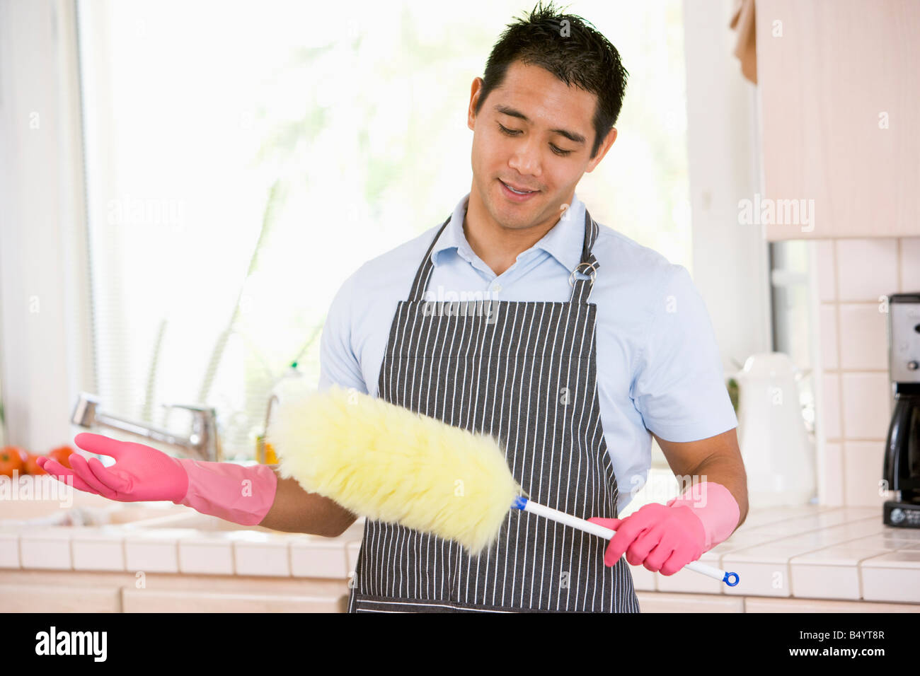 Man Holding Duster And Wearing Rubber Gloves Stock Photo - Alamy