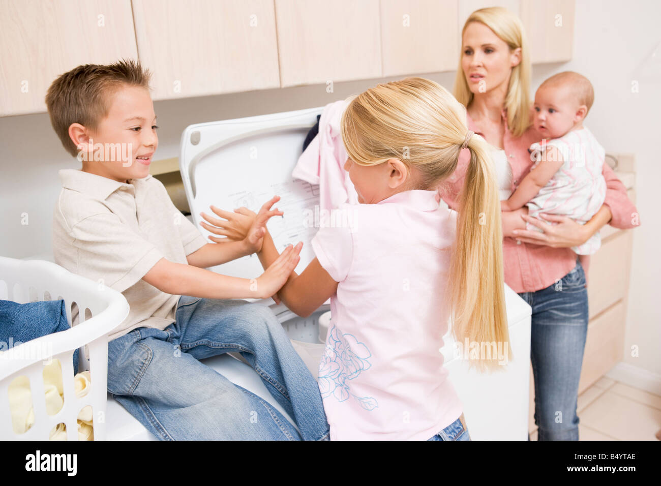 Siblings Fighting While Doing Laundry Stock Photo - Alamy