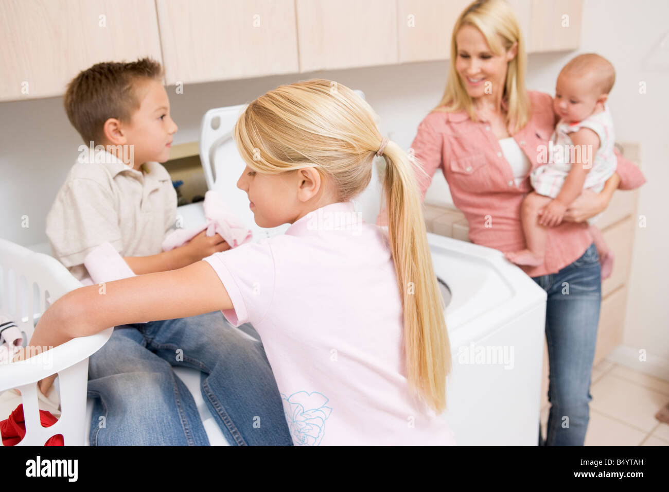 Mother And Children Doing Laundry Stock Photo - Alamy