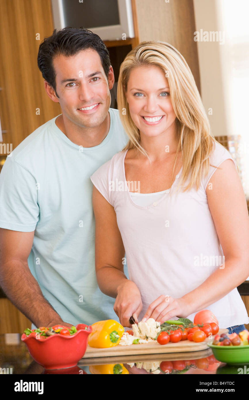 Husband And Wife Preparing Meal Together Stock Photo - Alamy